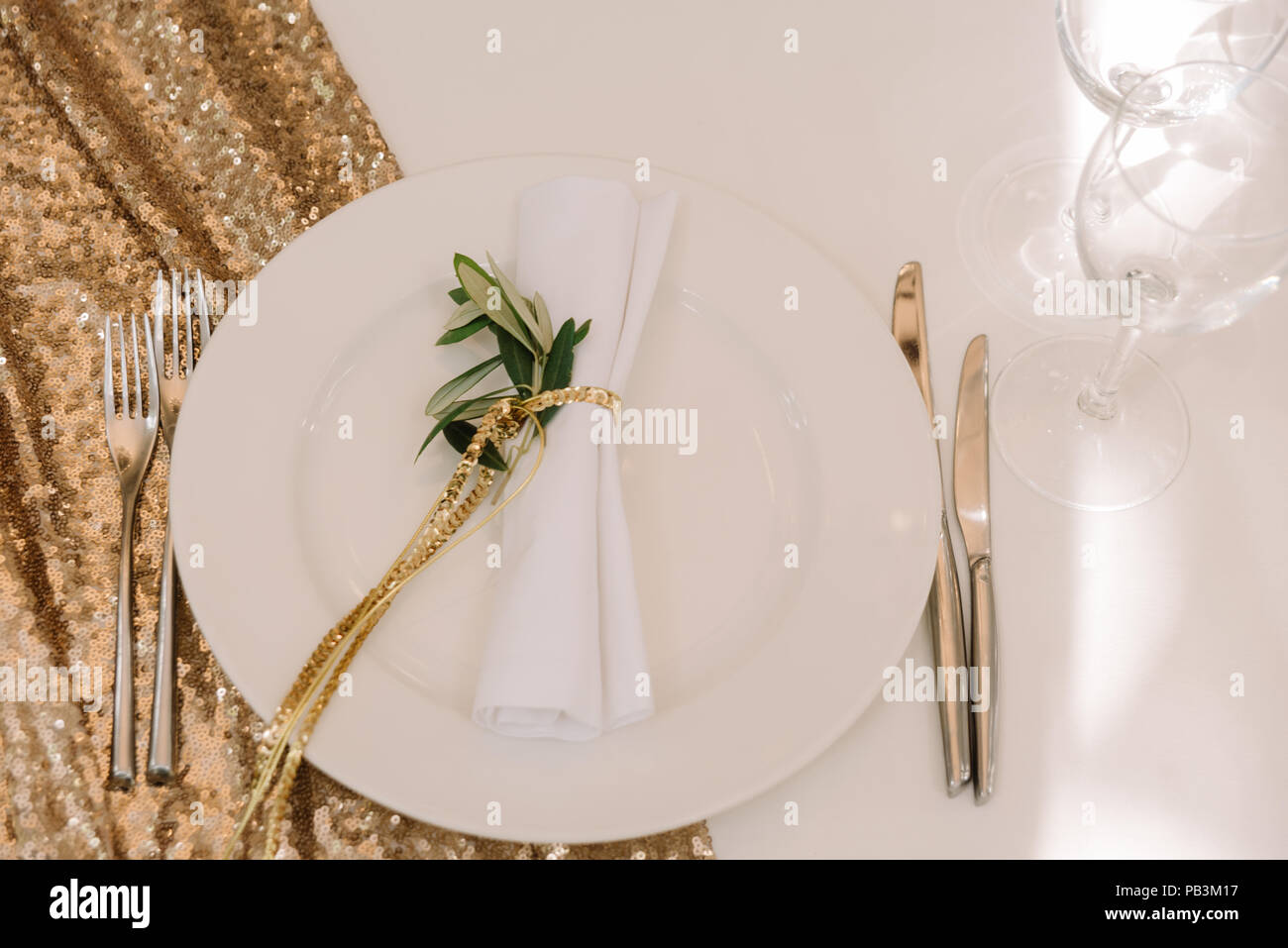 Table appointments of a holiday table. The white napkin decorated with ...
