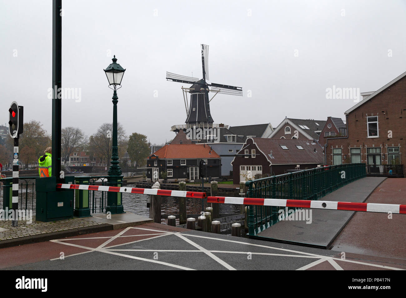 A barrier and red light signify the opening of a bridge over the River ...