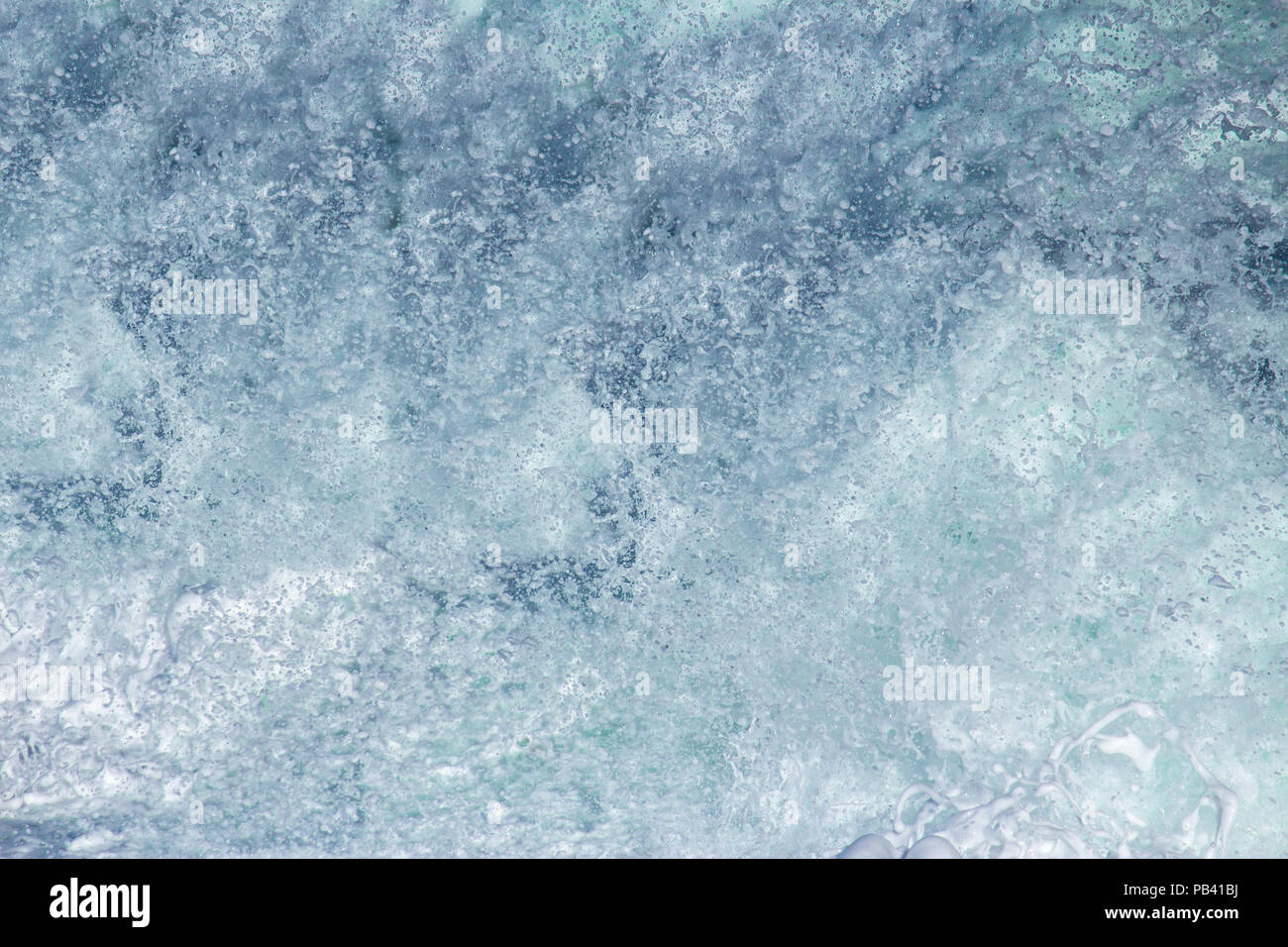 Aquatic background of sea surf waves close up with clear water and ...