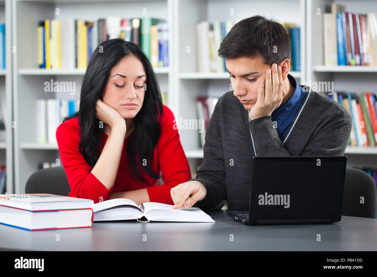 Happy students are learning in library Stock Photo - Alamy