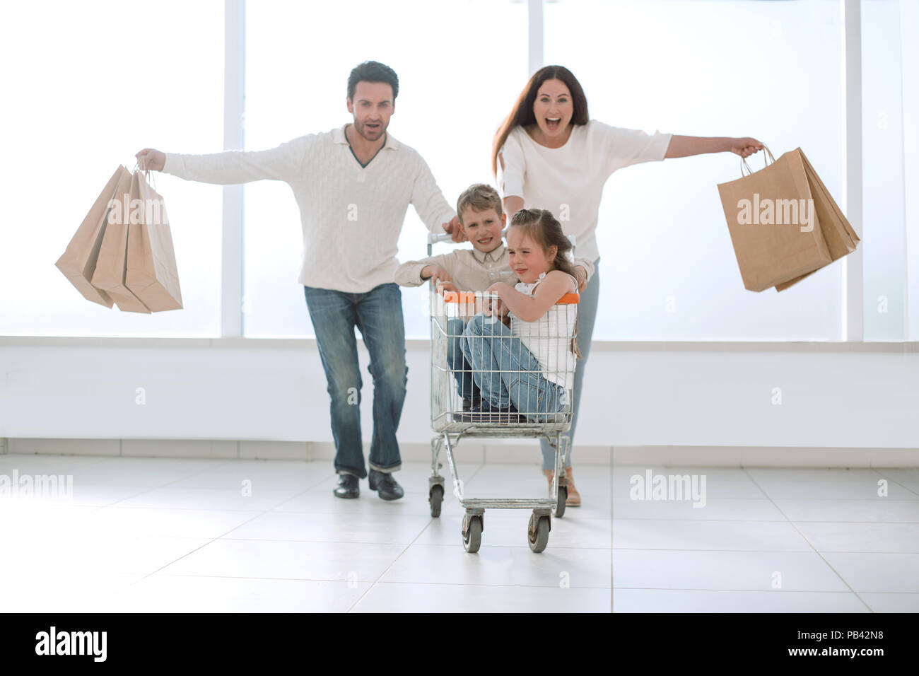 happy parents with children go shopping Stock Photo - Alamy