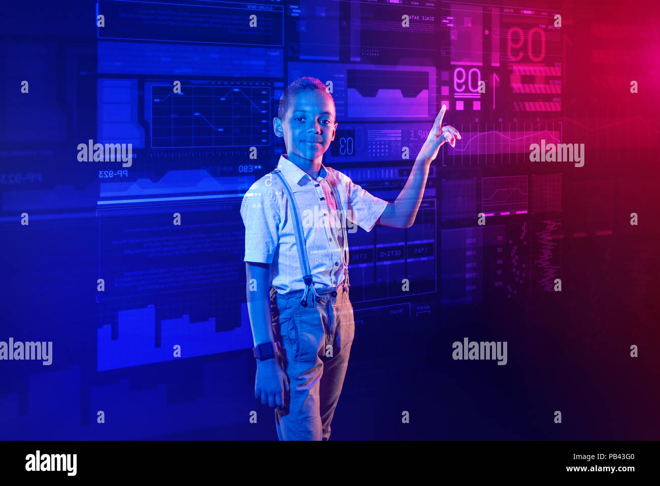 Pretty boy smiling and pointing to the screen Stock Photo - Alamy
