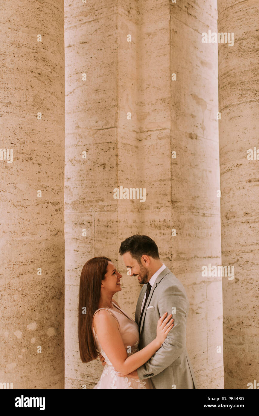 Young attractive newly married couple posing in Rome with beautiful and ...