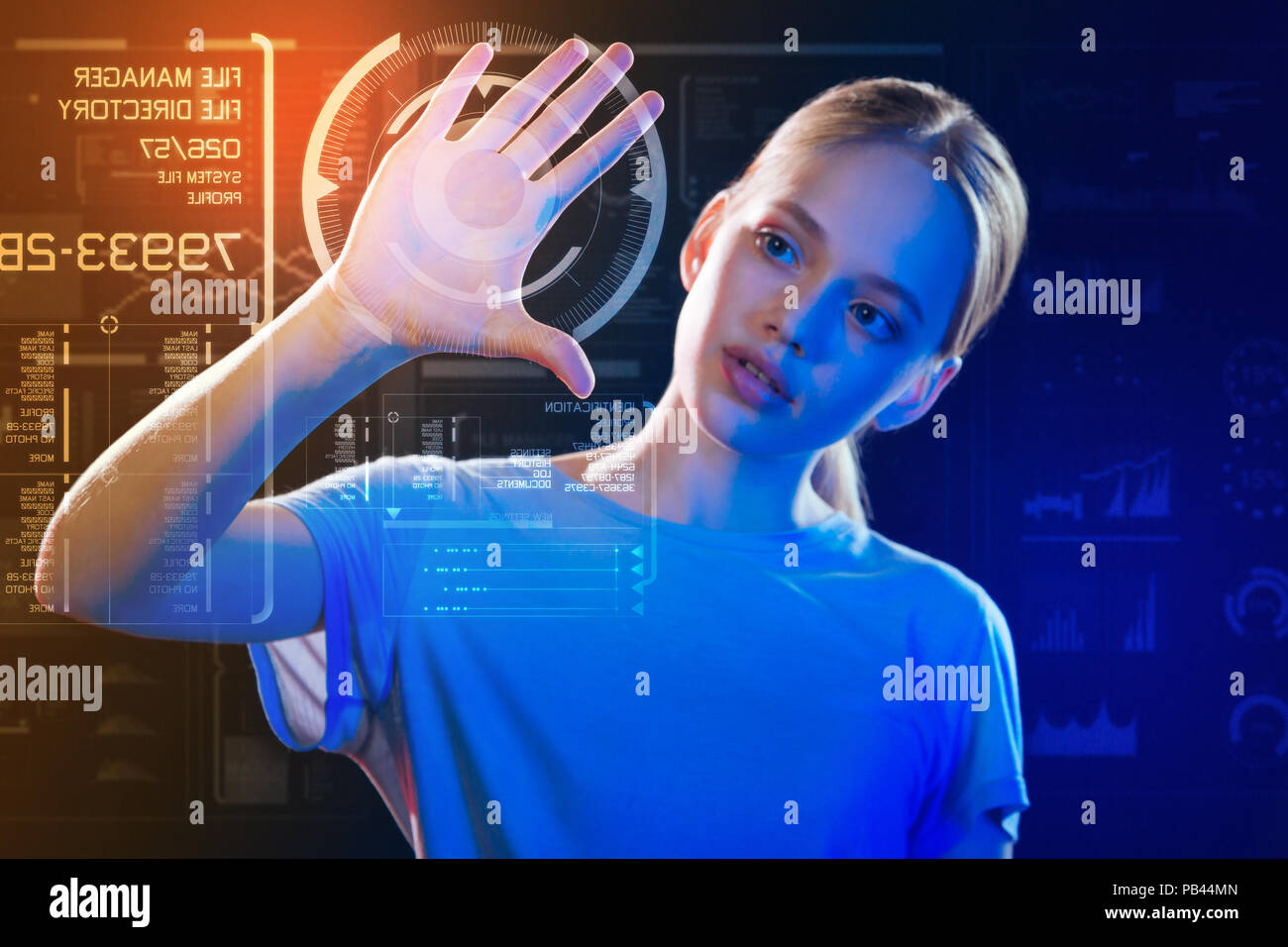 Curious girl touching the screen and scanning her hand Stock Photo - Alamy