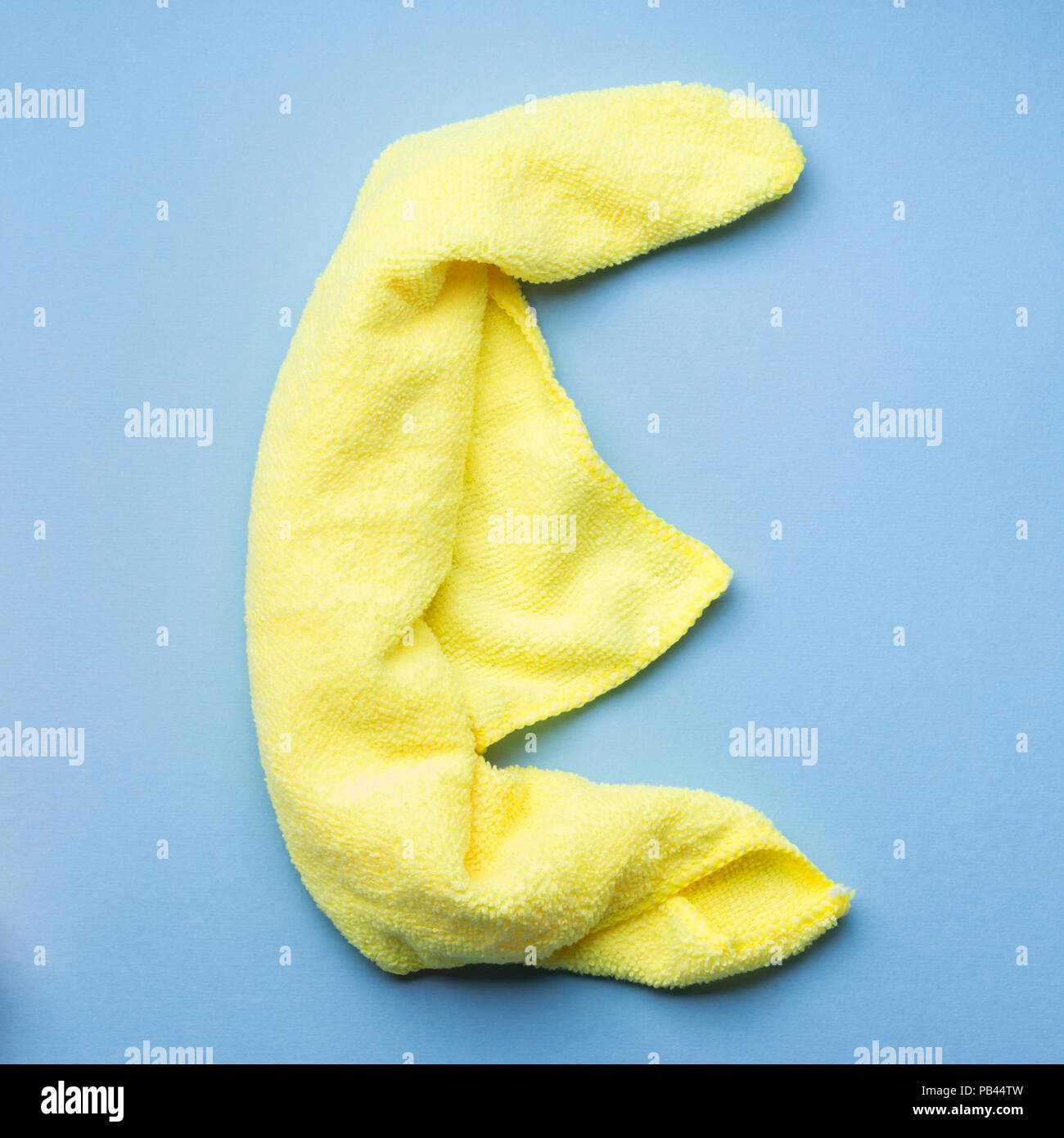 Letter E made with cleaning cloth on blue background. Part of word ...