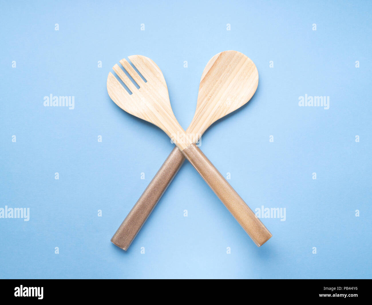 Minimal cooking, eating concept on blue background with wooden salad ...