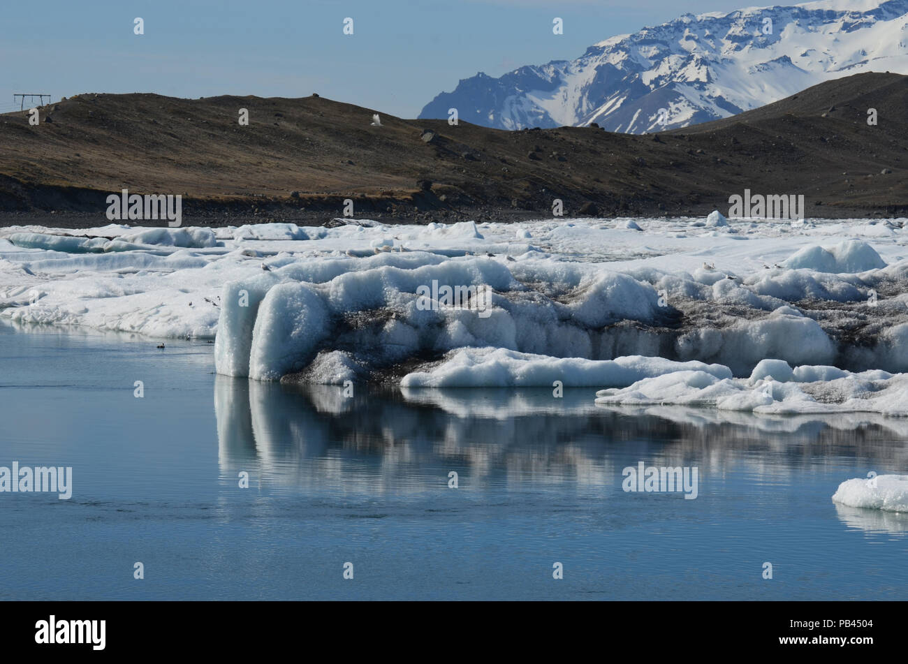 Beautiful side view of a large iceberg with a lot of sediment on its ...