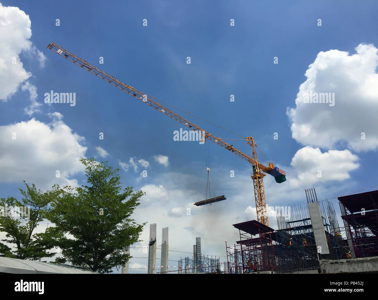 Industrial construction cranes on sky background Stock Photo - Alamy