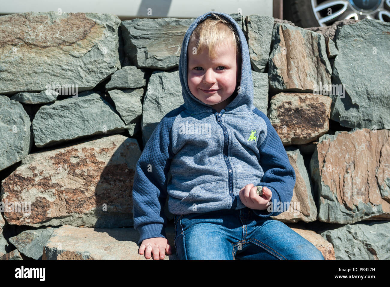 Boy sitting on a rock, Teide National Park, Tenerife, Canary Islands ...