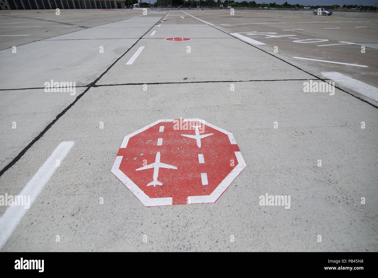 Traffic sign painted on the taxiway on the runway of an international ...