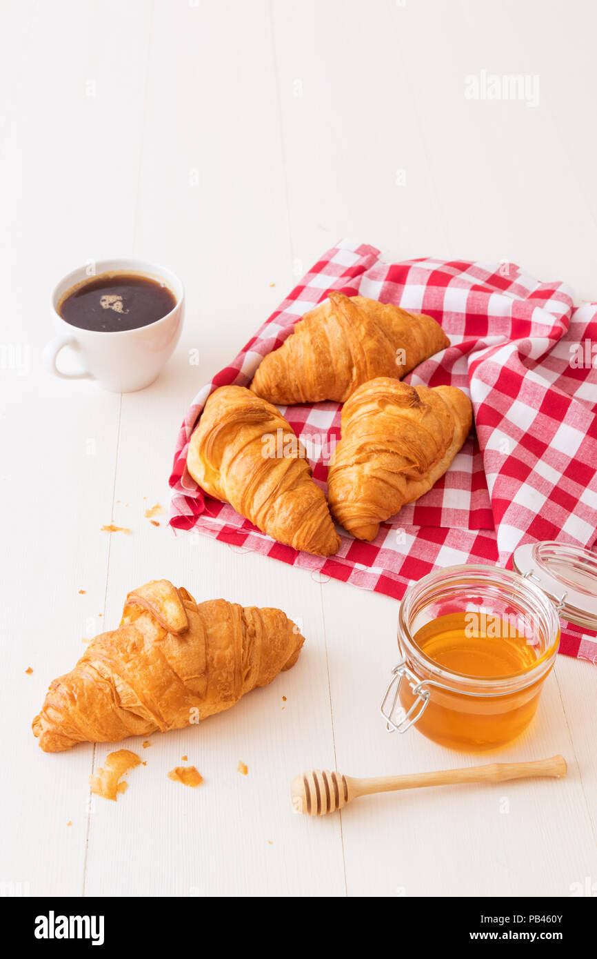 French style breakfast, a white wooden table with cup of coffee ...