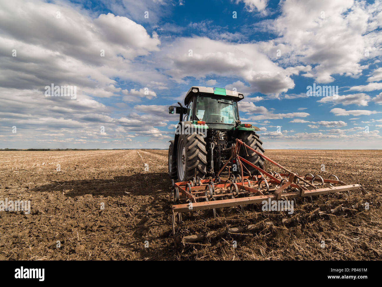 Tractor preparing land for sowing Stock Photo - Alamy