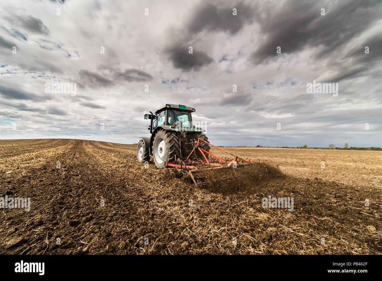 Tractor preparing land for sowing Stock Photo - Alamy