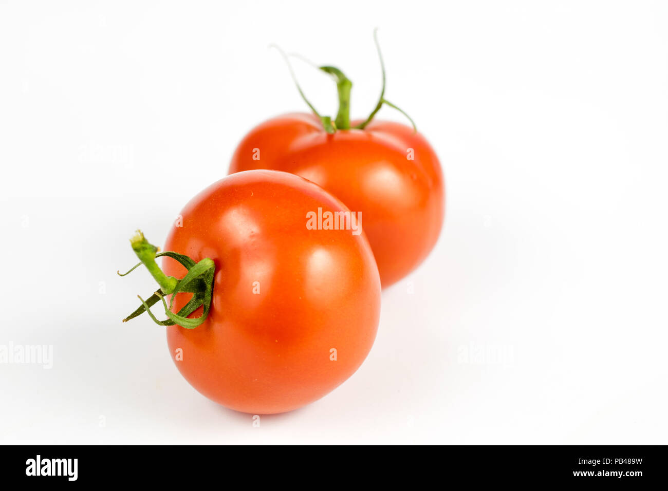 Red tomatoes on a white table. Tasty vegetables for the best dishes in ...