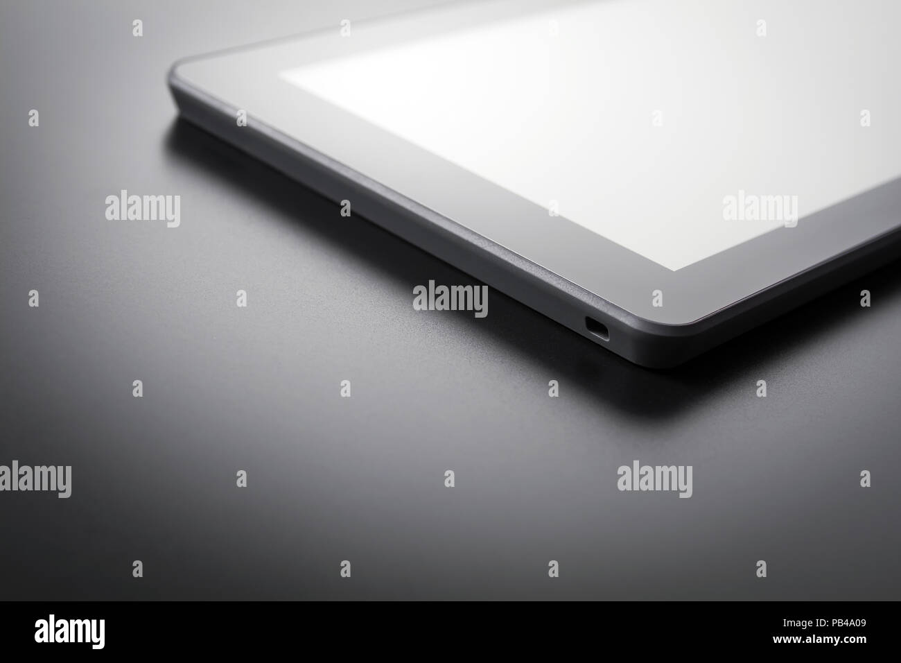 Black Tablet With Reflection Lying On A Dark Background Stock Photo - Alamy