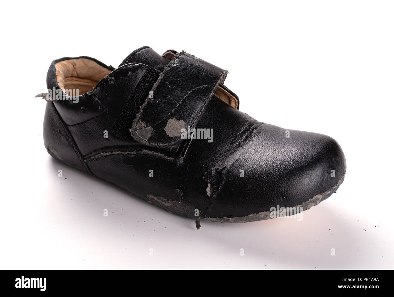 a badly broken leather shoe on white background Stock Photo - Alamy