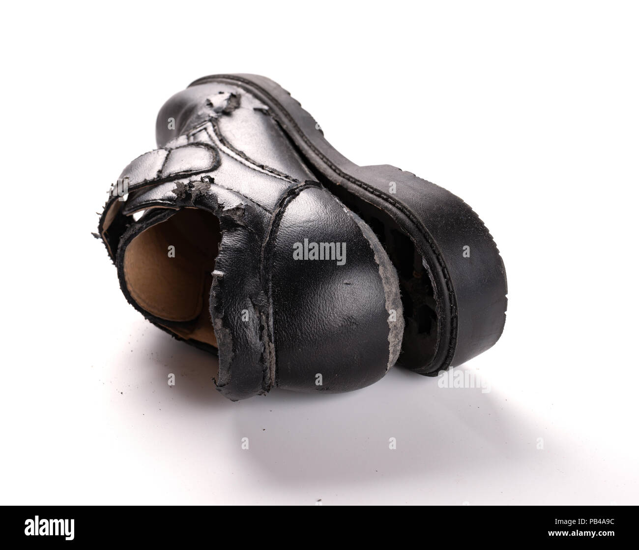 a badly broken leather shoe on white background Stock Photo - Alamy