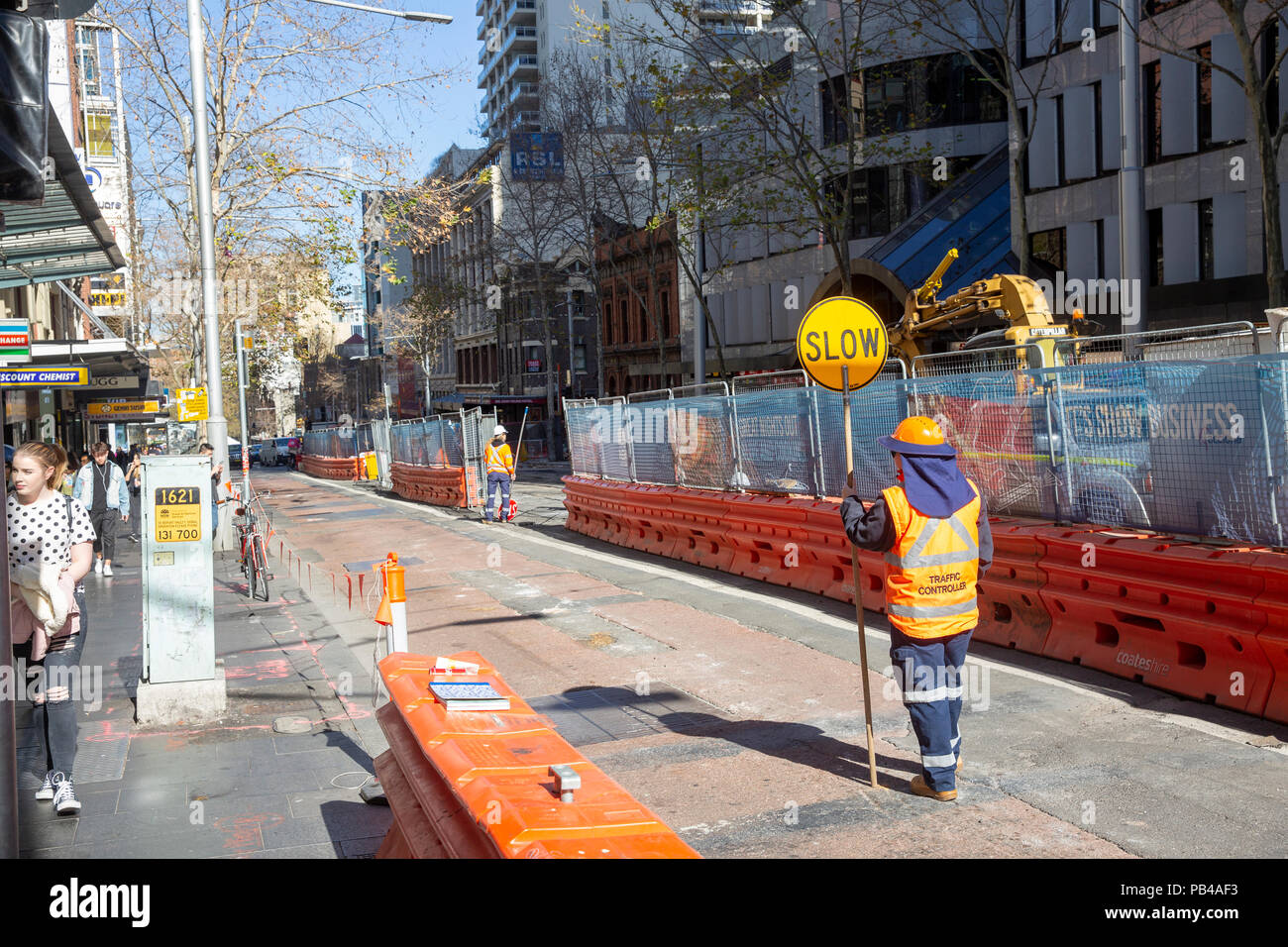 Female traffic controller manages traffic along George street in Sydney ...
