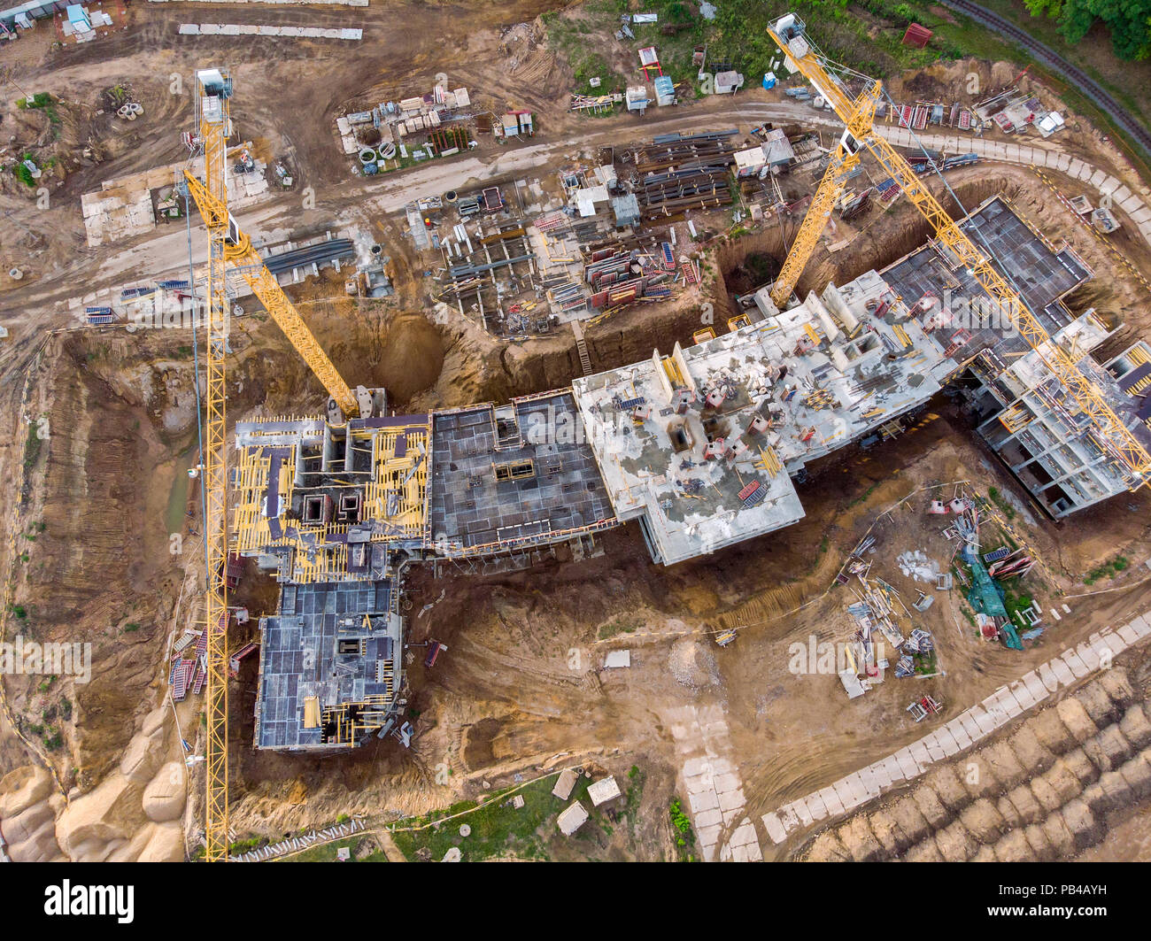 birds eye view on construction site with lifting cranes and future ...