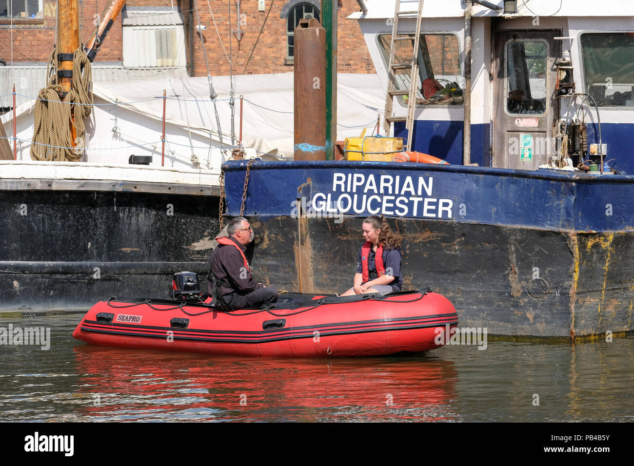 Canal dredger Riparian moored in Gloucester docks. Safety boat ...