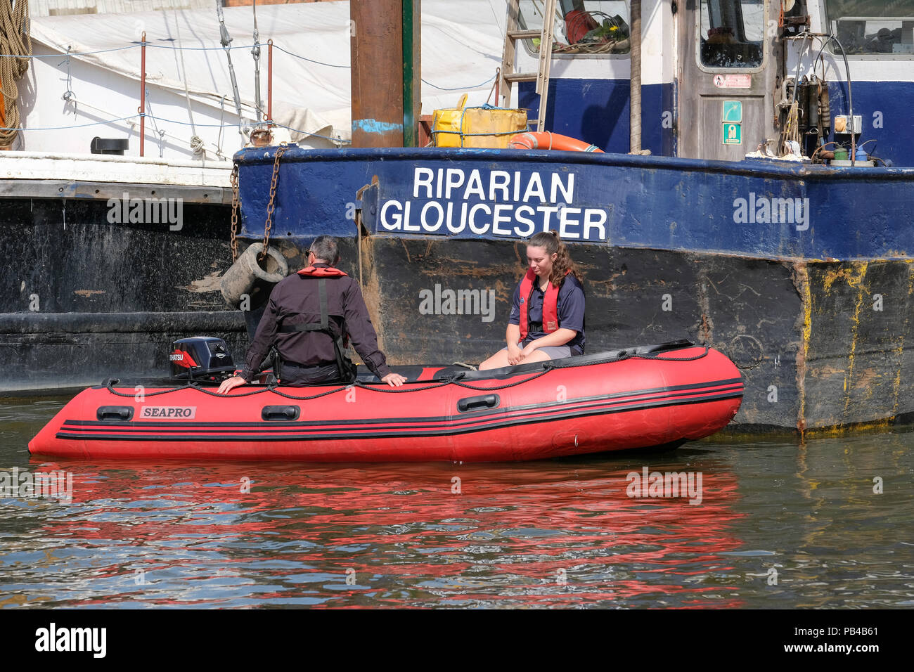 Canal dredger Riparian moored in Gloucester docks. Safety boat ...