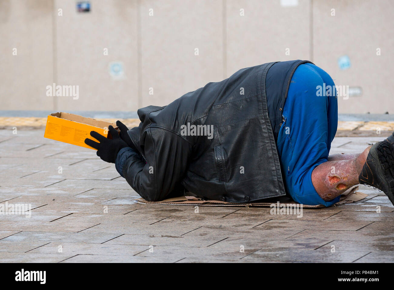 Man on knees begging in hi-res stock photography and images - Alamy