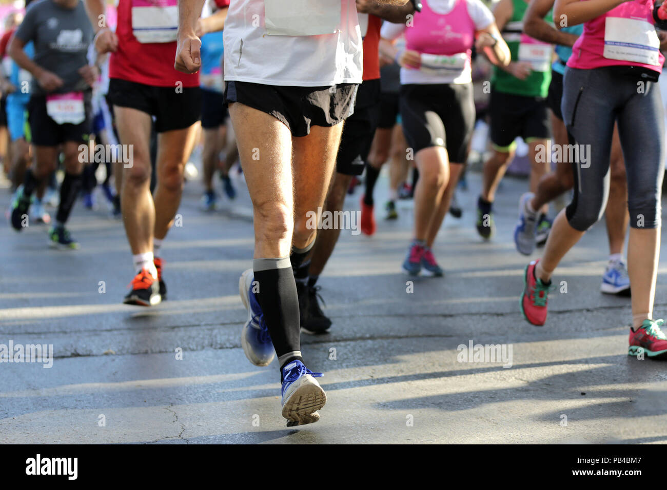 Marathon running race. Legs and bodies only. Unrecognizable people. The ...
