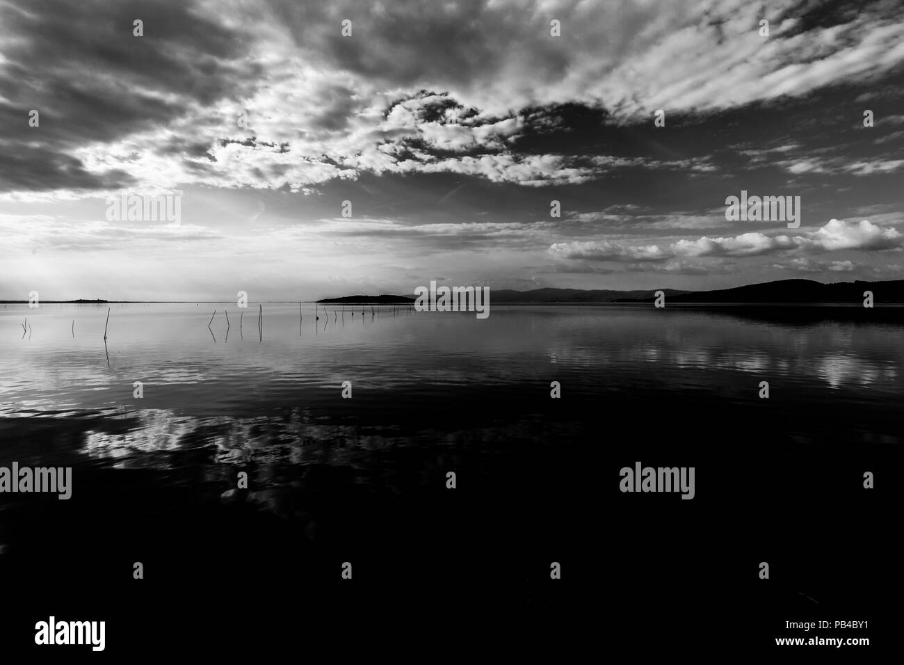 Perfectly symmetric and spectacular view of a lake, with clouds, sky ...