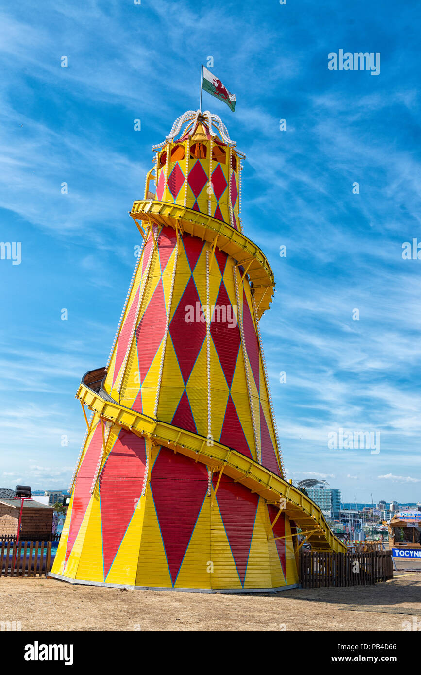 The fairground at The Beach in Cardiff Bay, South Wales, UK under a ...