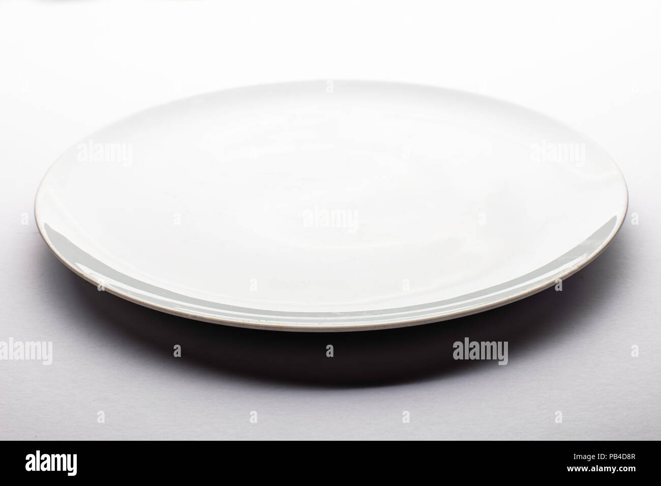 White plate front view isolated on white background Stock Photo - Alamy