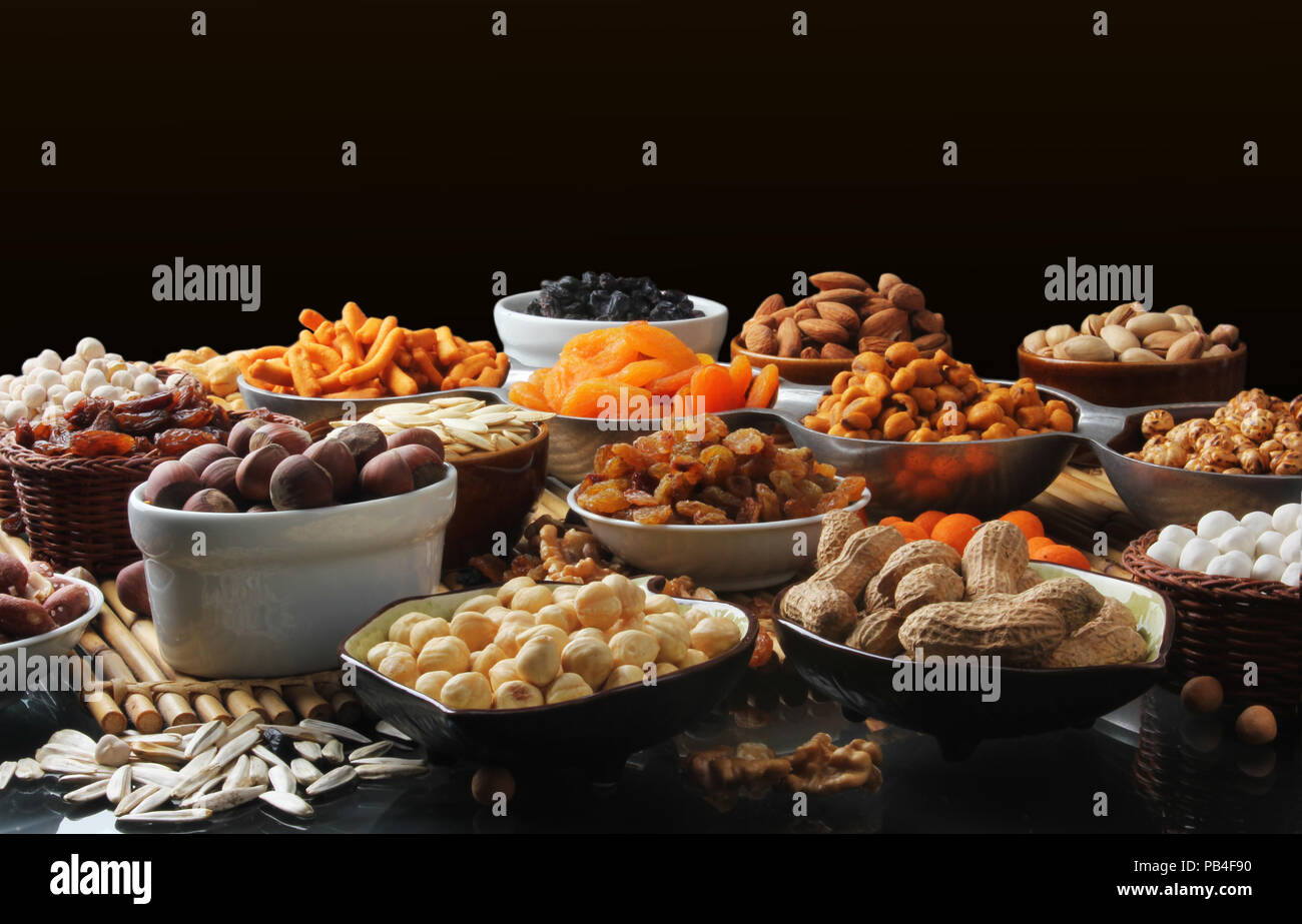 Nuts family on dark background Stock Photo - Alamy