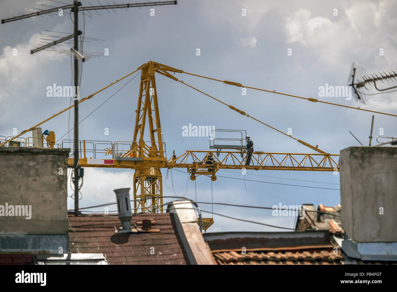 Belgrade, Serbia - Workers repairing a construction crane high above ...