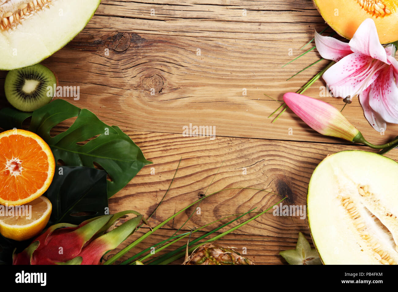 Tropical fruit. Assortment of tropical fruits with leaves of palm trees ...