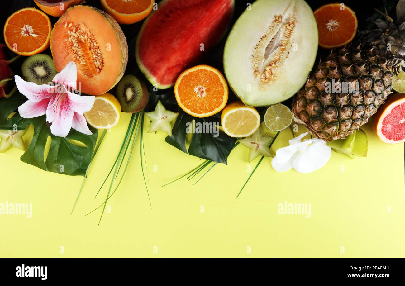Tropical fruit. Assortment of tropical fruits with leaves of palm trees ...