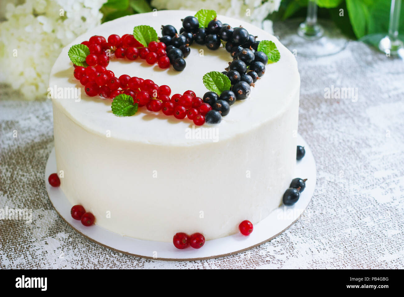 Round white cake with berries in the form of hearts, Valentine's Day ...