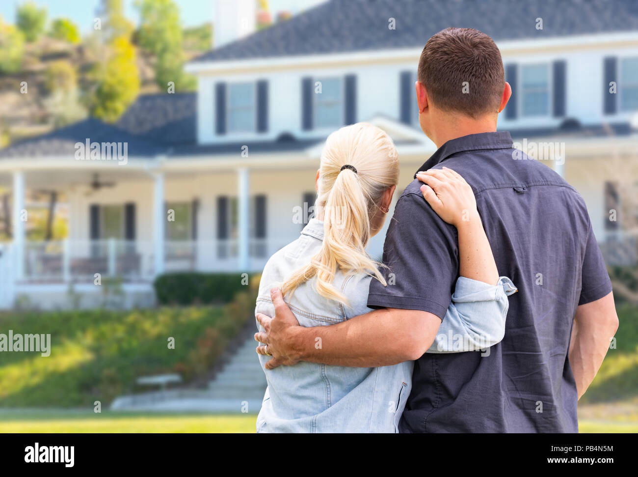 Young Adult Couple Facing Front of Beautiful House Stock Photo - Alamy