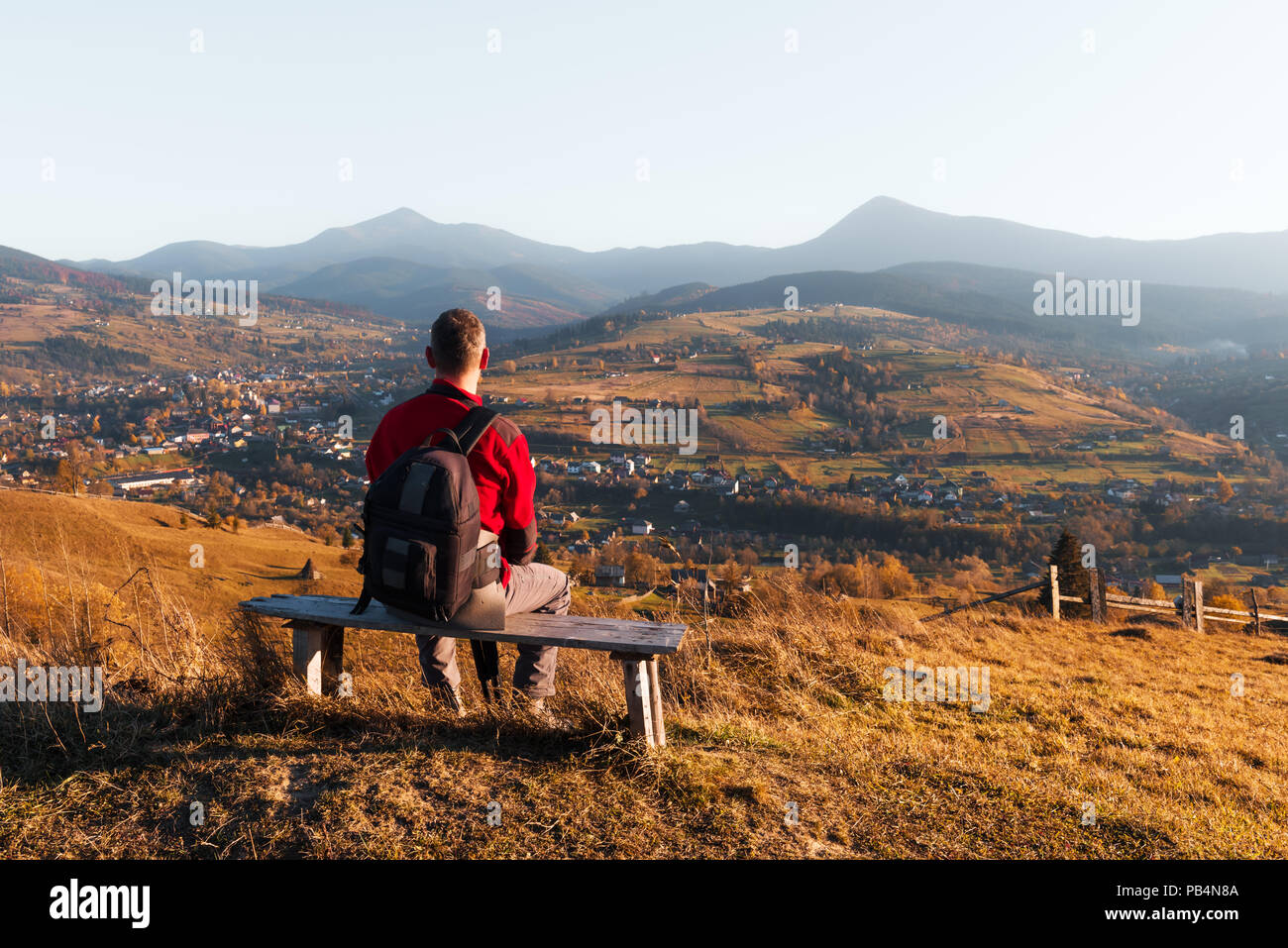 Photographer seating on wooden bench Stock Photo - Alamy