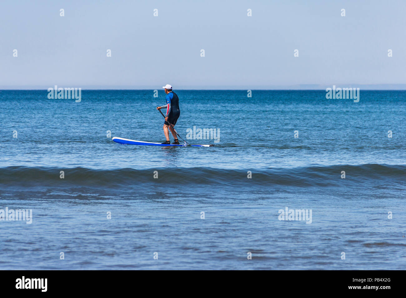 A single paddleboarder on the sea at Westward Ho!, Devon, UK Stock ...