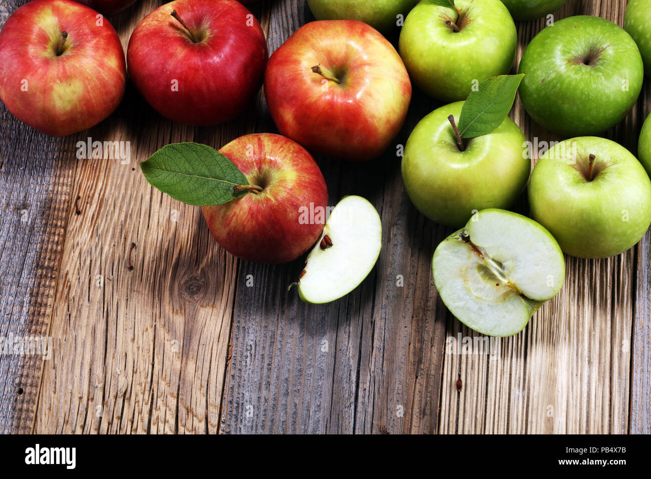 Ripe red apples with leaves on wooden background Stock Photo - Alamy