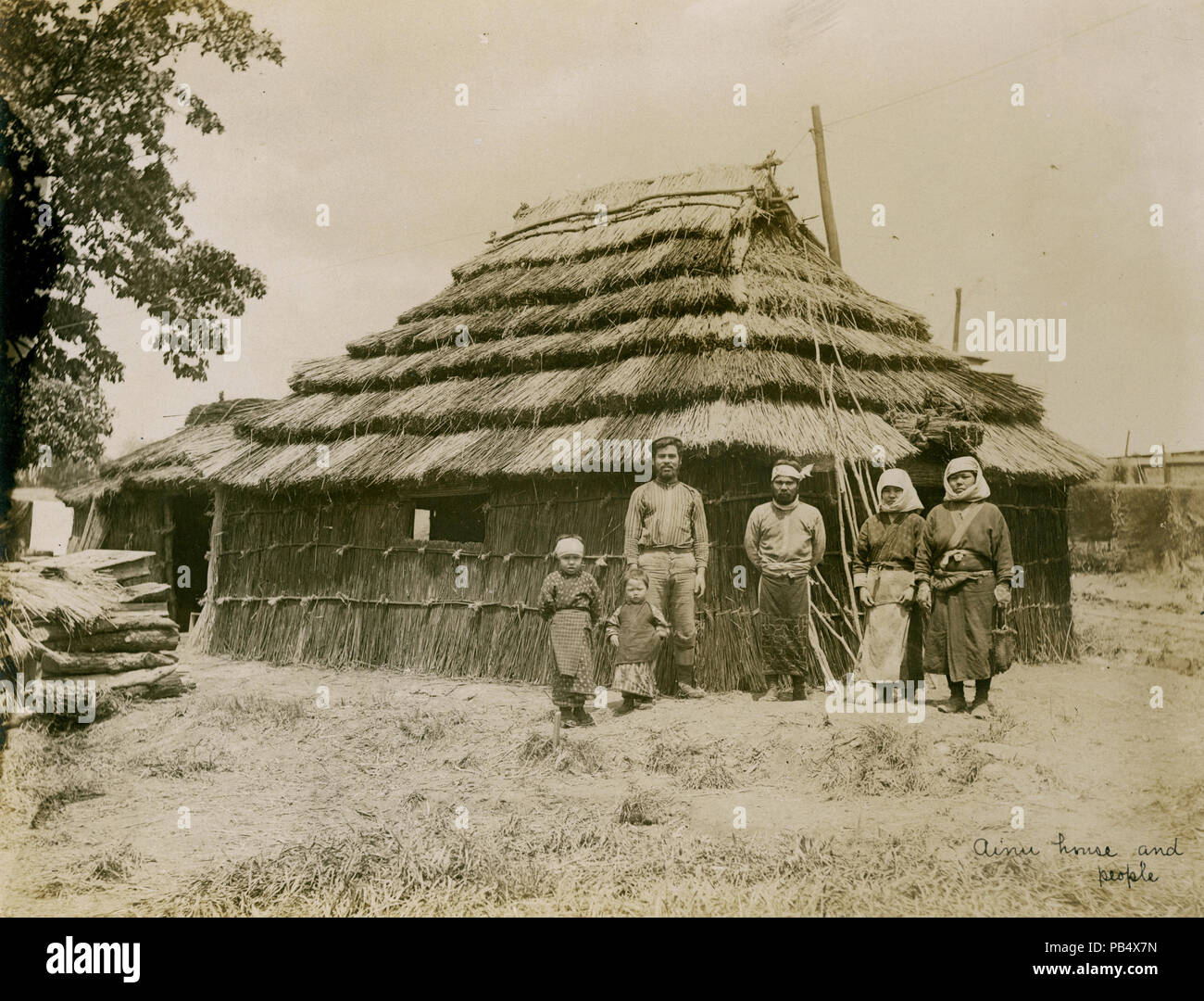 826 Japanese Ainu family in front of their dwelling in the Department ...