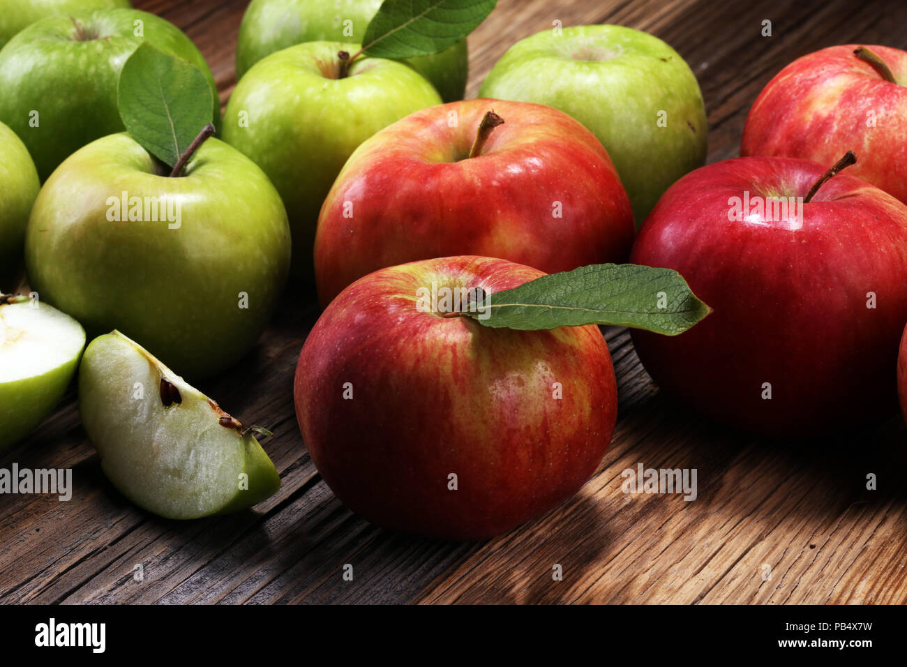 Ripe red apples with leaves on wooden background Stock Photo - Alamy