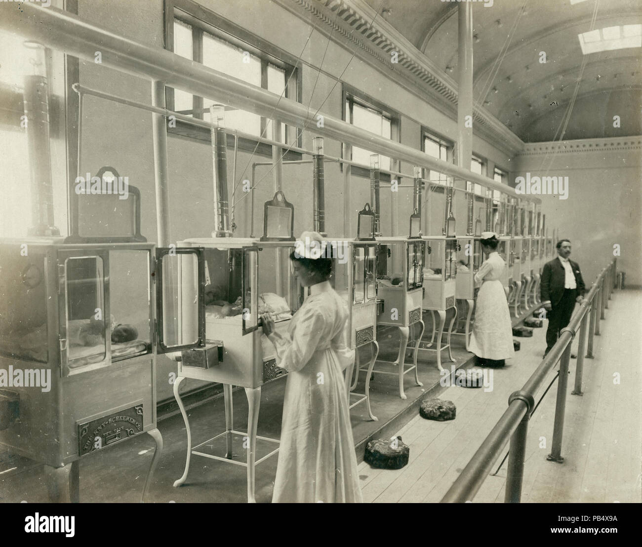 990 Manager, Mr. E.M. Bayliss and nurses attending babies in the Baby ...