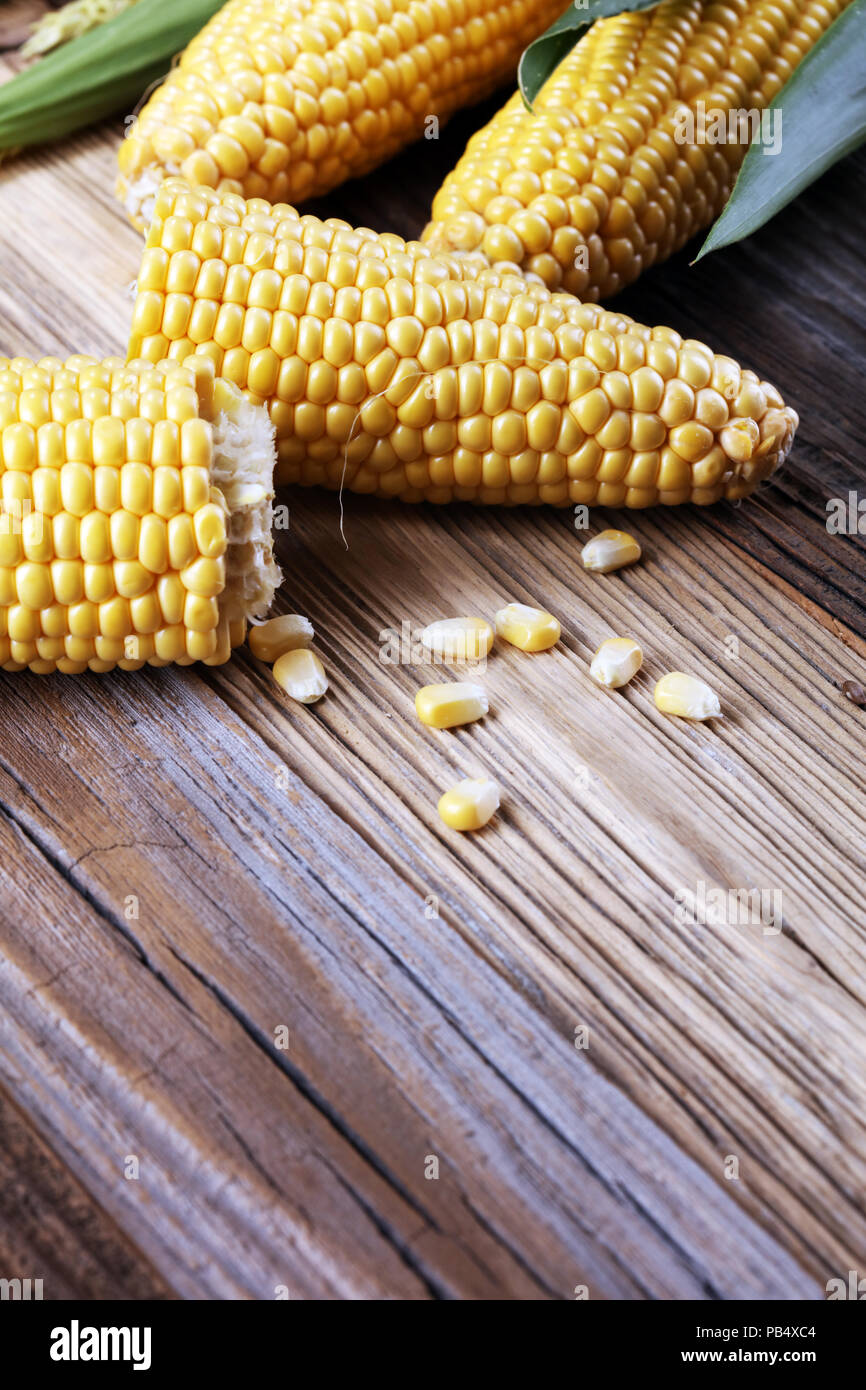 Fresh corn on cobs on rustic wooden table Stock Photo - Alamy