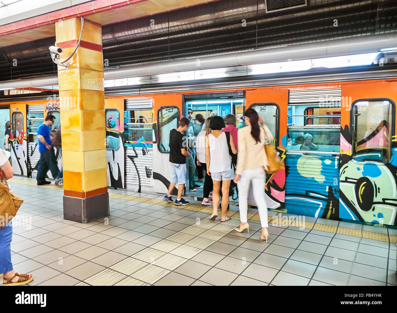 Athens, Greece - June 29, 2018. People taking a train painted with ...