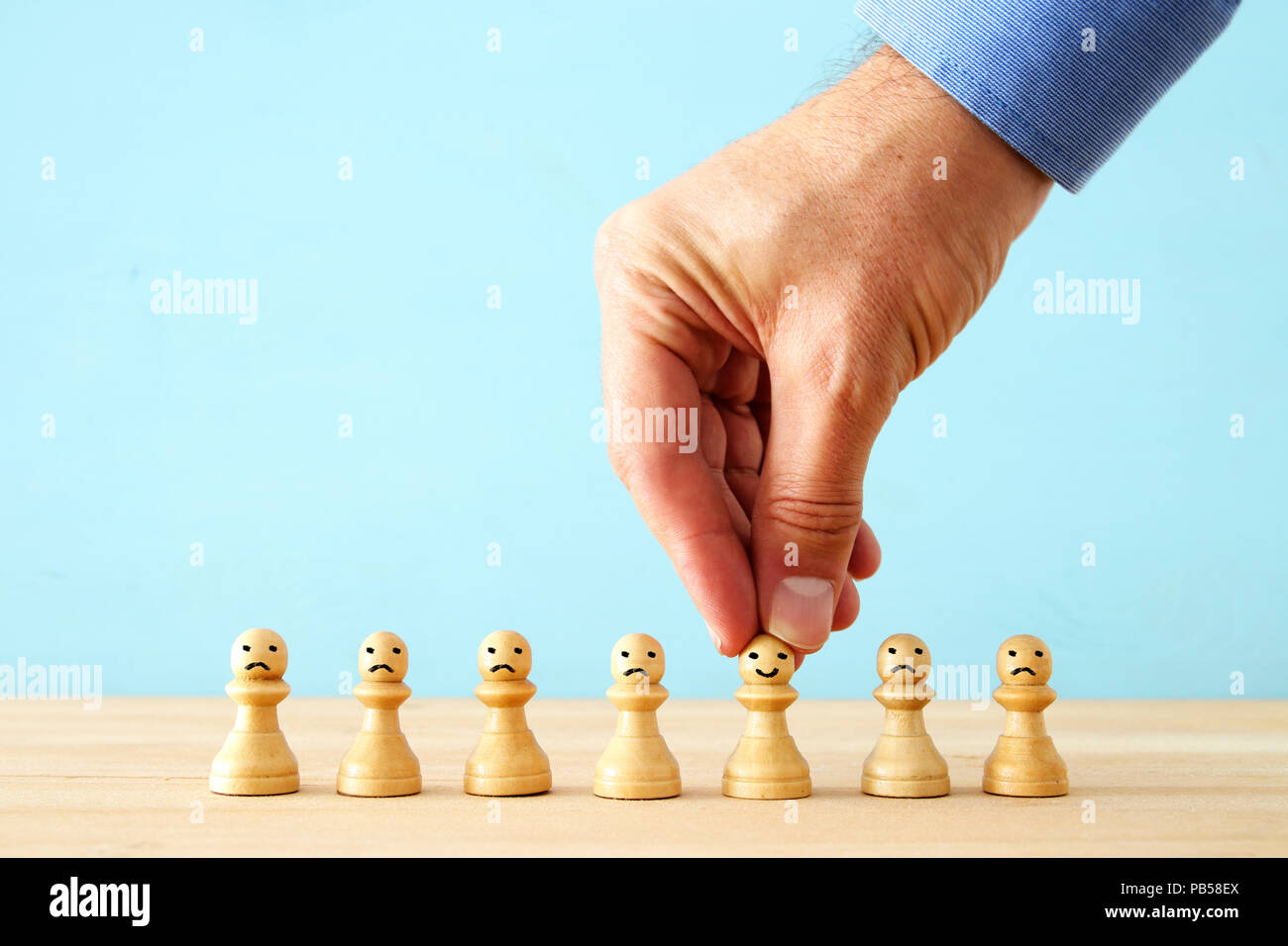 concept image of chosen person among others. a smiling chess pond ...