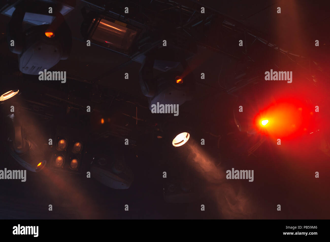Red stage lights, strong spot beams in smoke over dark background ...