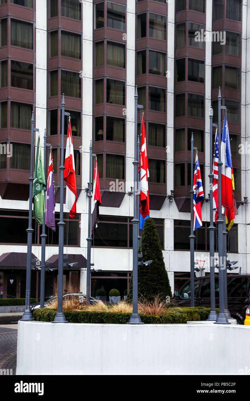 The flags on the masts in front of the building Stock Photo - Alamy