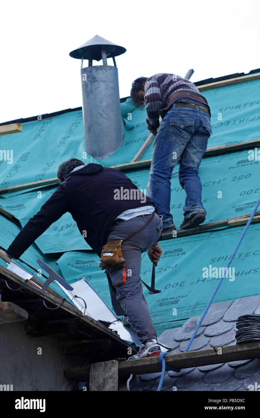Repair of a roof by two workers Stock Photo - Alamy