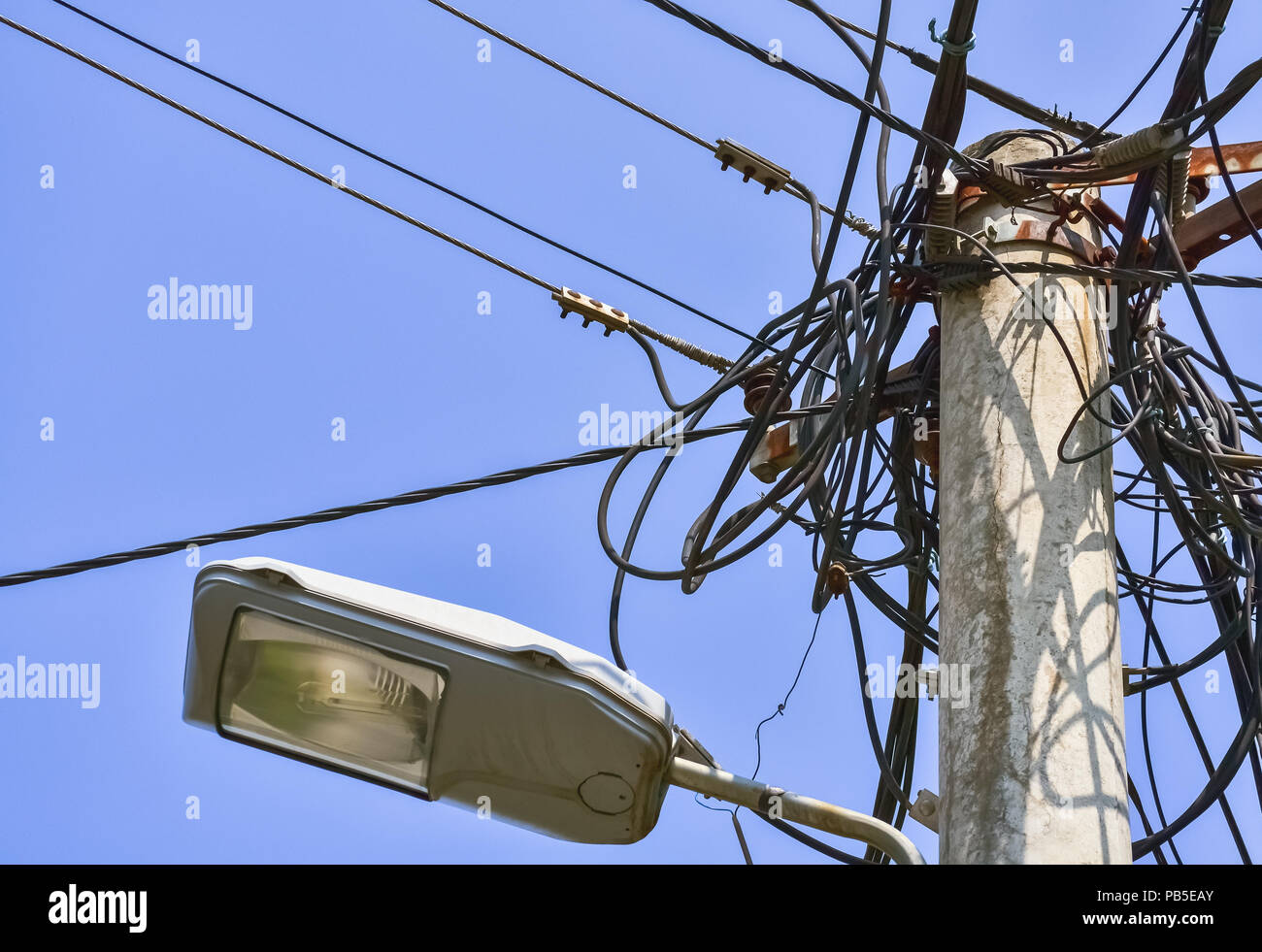 Dangerous mess of electric cables on the street lamppost Stock Photo ...