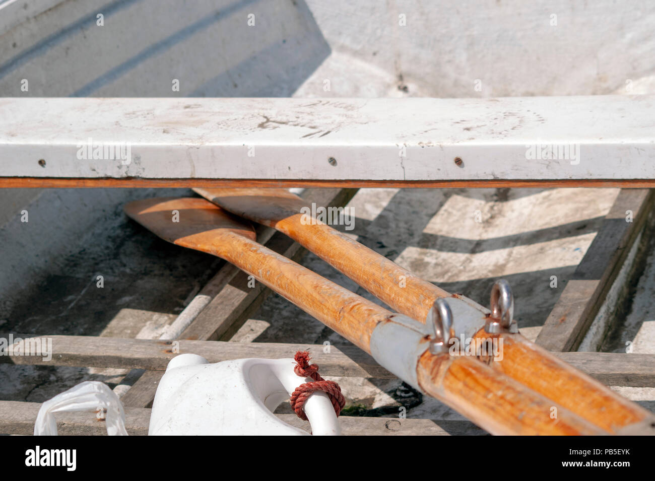 Interior of a fishing rowing boat with oars Stock Photo - Alamy